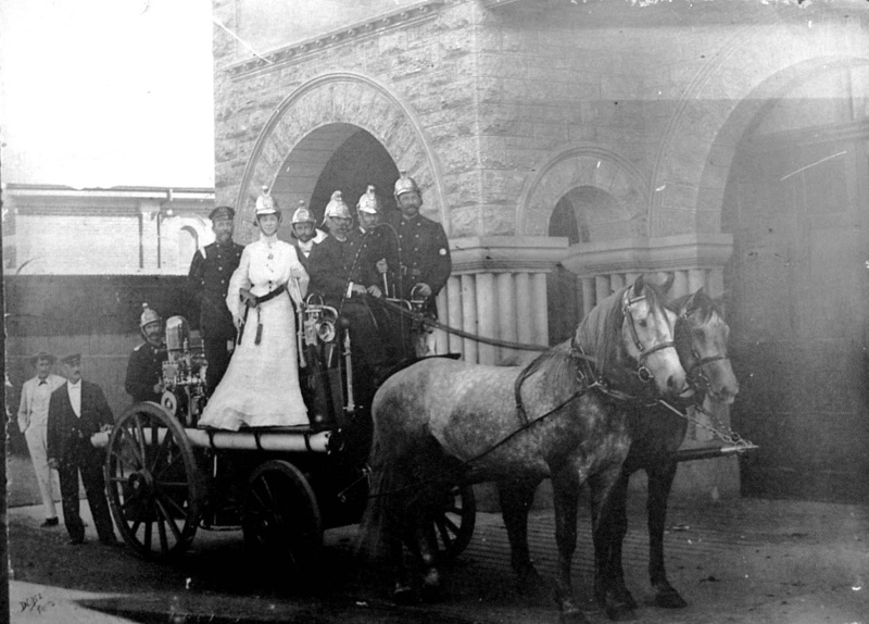 Photograph, Ada Crossley standing on a horse drawn steam pumper outside ...