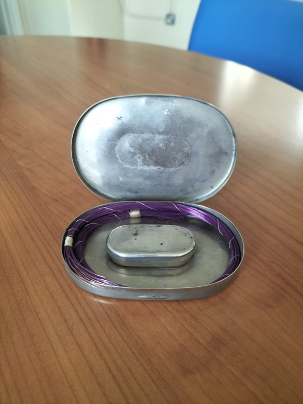 Tin box with purple surgical thread and smaller compartment that would ...