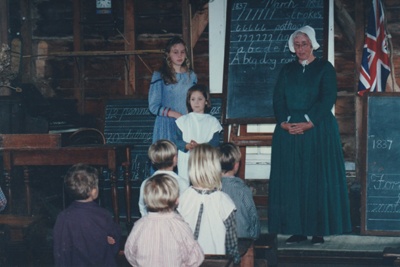A teacher (possibly Peace Toone) and pupils at the front of Ararimu ...