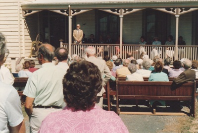 People watching John Stackpoole on the verandah of Puhinui, giving the ...