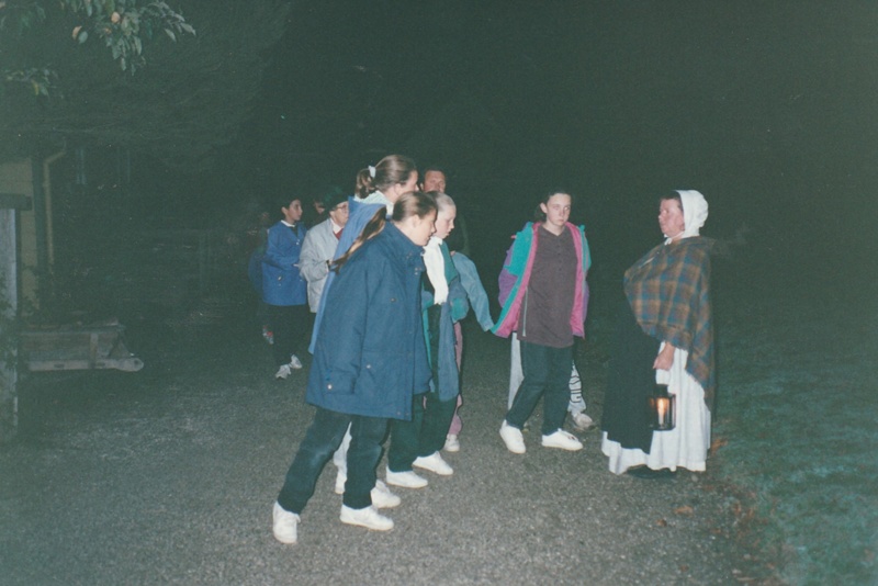 Debbie Benson in costume, with visitors during a Candle lit tour at ...