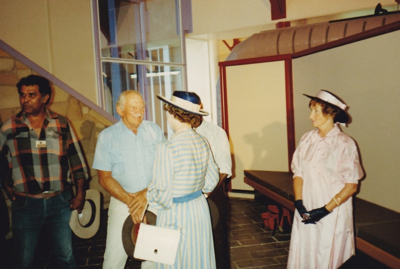 Photograph of HRH The Queen (back to camera) talking to people inside ...