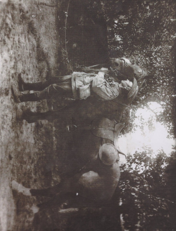 Portrait of WW1 digger standing with bridled and saddled horse, holding ...