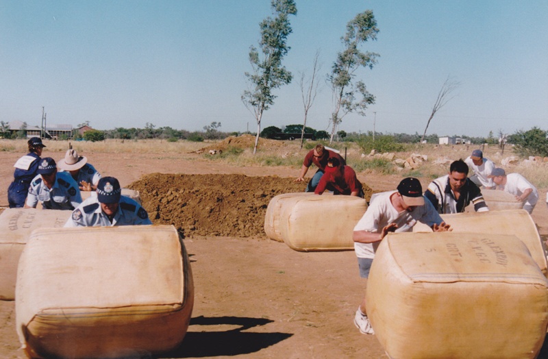Photograph - Nine contestants rolling full bales of wool at Outback ...