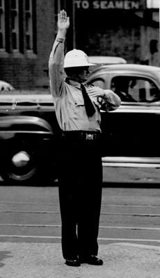 Constable Bill English directs traffic with his distinctive whistling ...