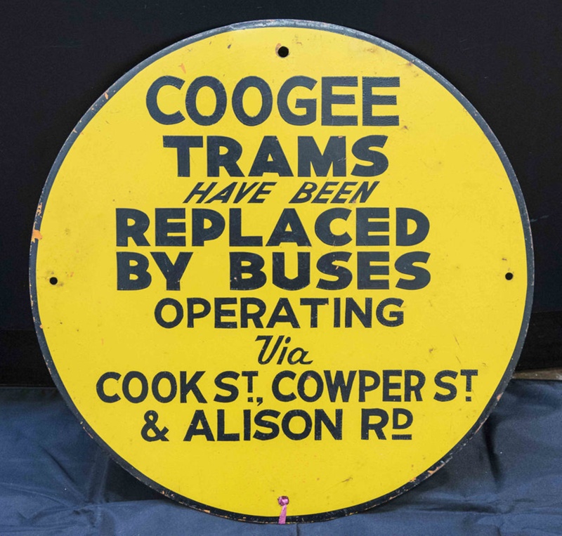 Sign, metal, circular, painted, Coogee Trams have been replaced by ...