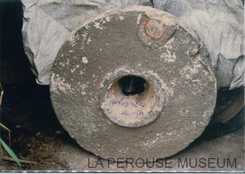 Colour print photograph of a millstone with purple ink marks on the ...
