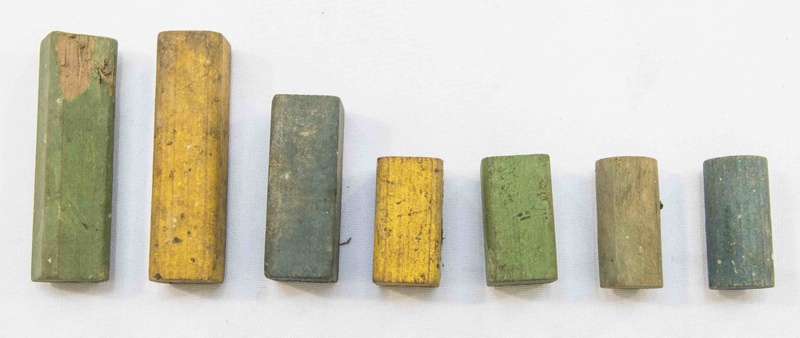 Set of five narrow rectangular wooden blocks and two cylindrical blocks ...