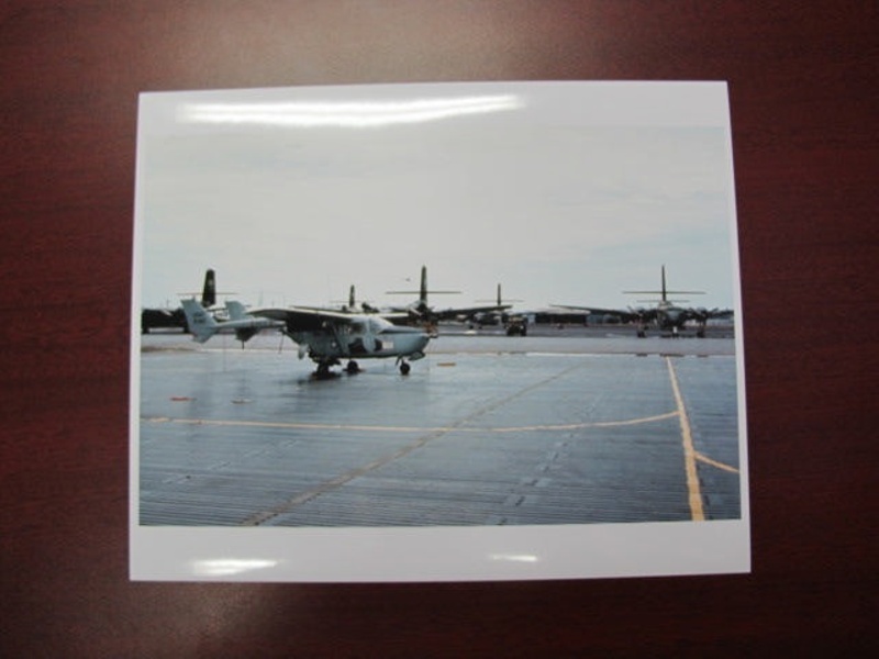 Cessna O-2A USAF 21383 on the ramp with five Caribous behind; c. 1970 ...