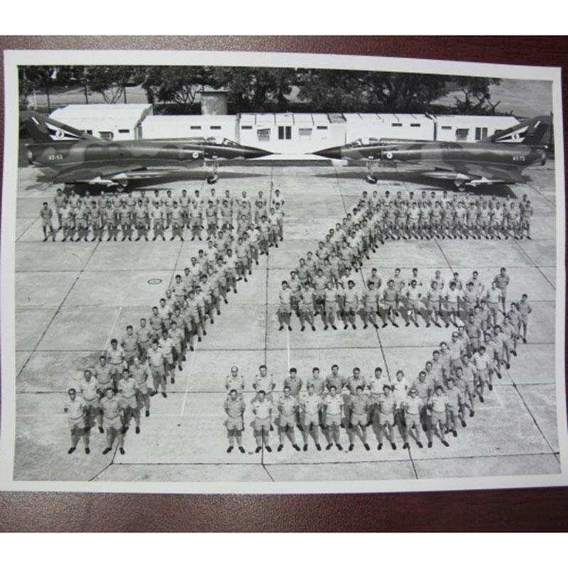 Members of 75 Squadron stand in formation of the number 75 with two ...