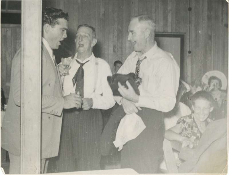 Claude Neilson, Charlie Corney & unidentified man at dinner reception ...