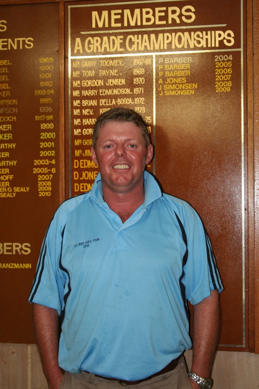 Chad Driscoll standing in front of the Hughenden Golf Club Honour Board ...