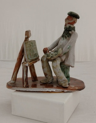 Ceramic figure of a painter sat at an easel; Marie Whitby; 1978; 2021. ...