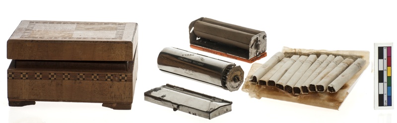 Cigarette rolling box containing a concinnum machine, rolling papers ...