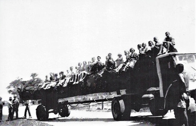 Photographs (2) of Daniel Benfer's timber truck with a large group of ...