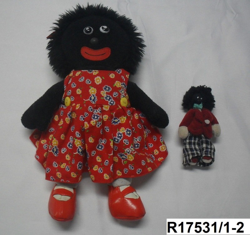 1. A small female black golliwog in a red dress with a red ribbon in ...