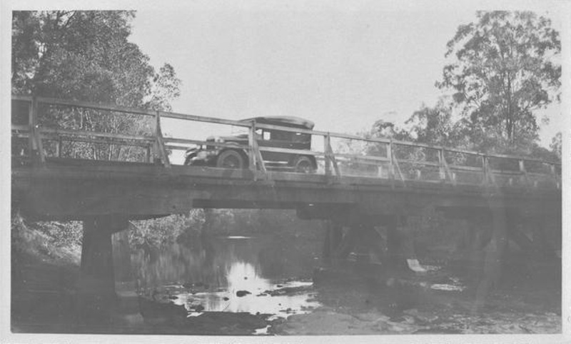 Photograph of a Motor Car crossing the first bridge over Tingalpa Creek ...