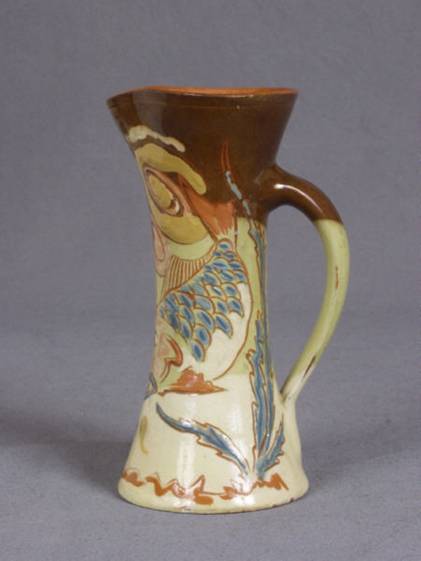 Brown/cream waisted cylindrical jug with fish design in tan and blue ...