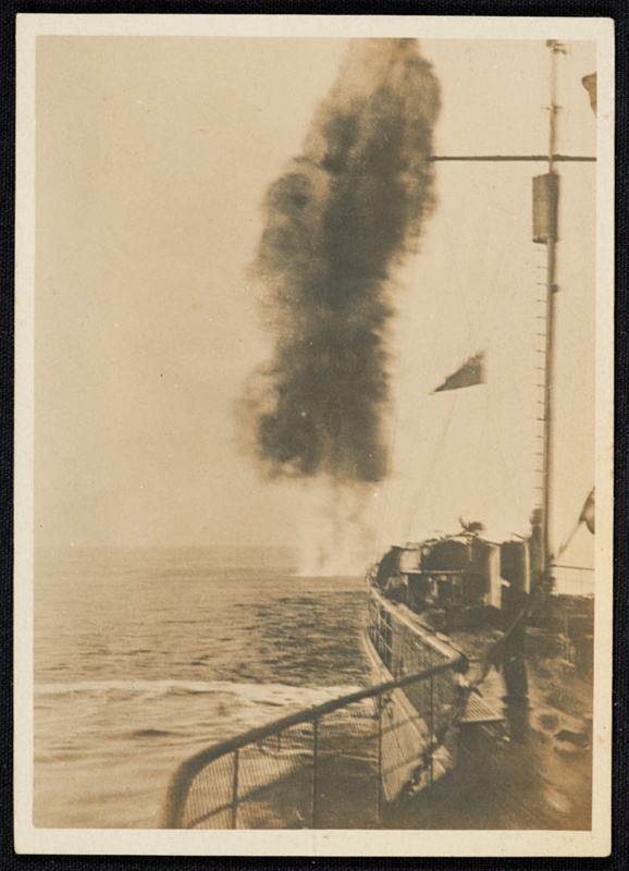 View over the bow of a ship of a mine exploding at sea.; Unknown; 1900 ...