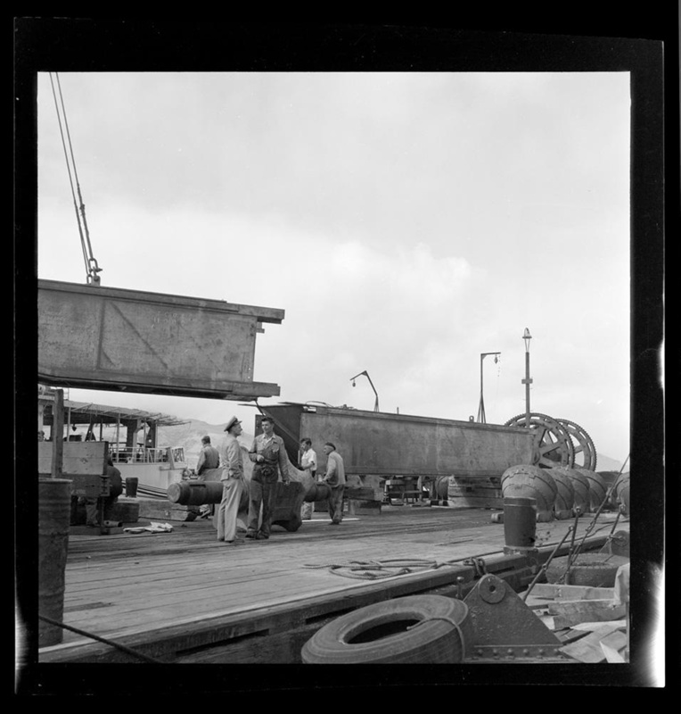 Skipper of floating crane 'Rapaki' in discussion with another man ...