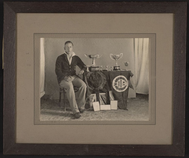 Pat Johnson next to table holding trophies and awards. Glazed, wooden ...