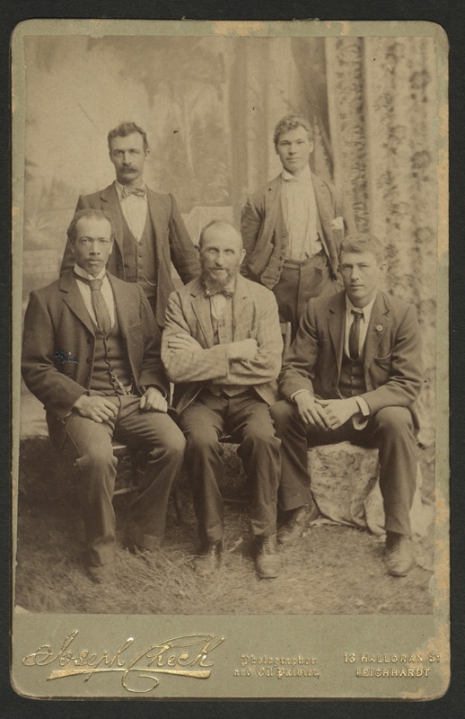 Studio portrait of five men, with Ralph Nattress in centre and his son ...