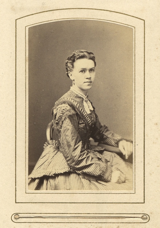 Studio photo of a seated lady in formal attire with small bow tie.; J ...