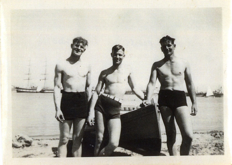 Photograph of Sam Pooley (right) with two friends on the foreshore ...