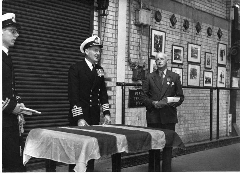 Photograph of the Captain J.F. Whitfield DSC RN.with a Lieutenant and a ...