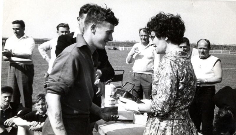 Photograph of Mrs. Drake, wife of Commissioned Gunner Drake, presenting ...