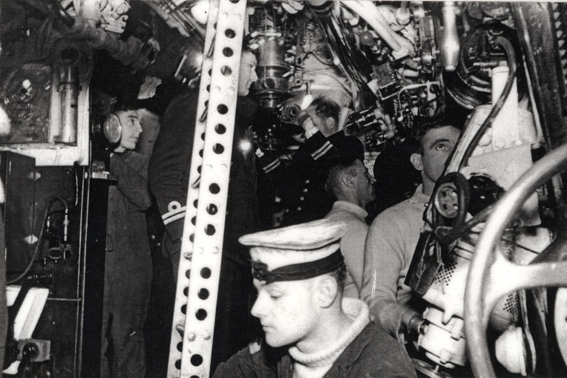 Copy photograph of a submarine at 'Diving Stations' with the Commanding ...