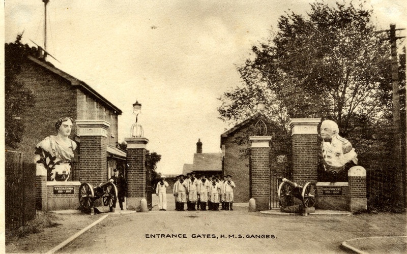 Photograph of boys dressed in 'duck suits' marching through main gate ...
