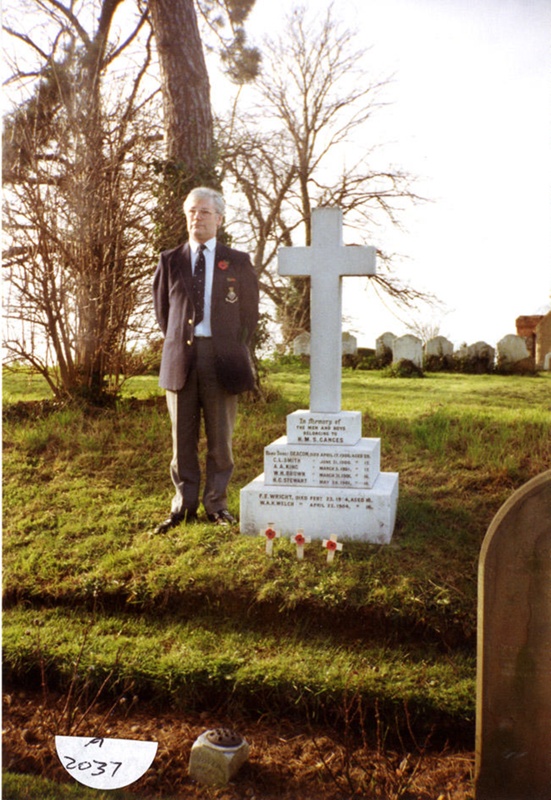 Photograph of Robbie Robson standing beside HMS Ganges Memorial in ...