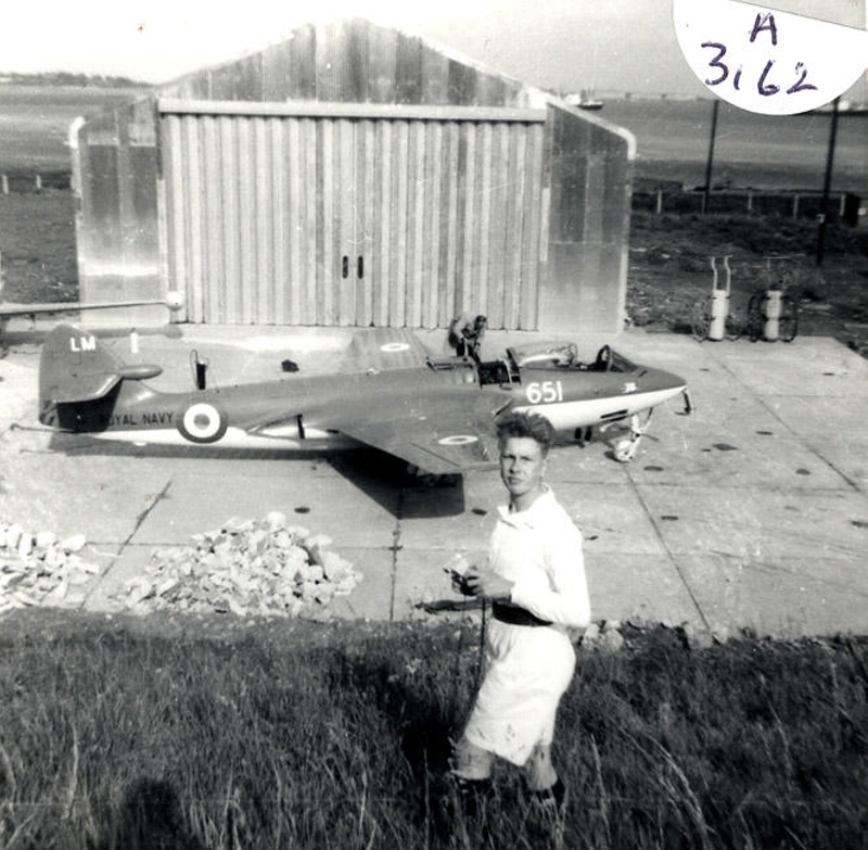 Photograph of Junior, Terry Abrams, with an aircraft in the background ...