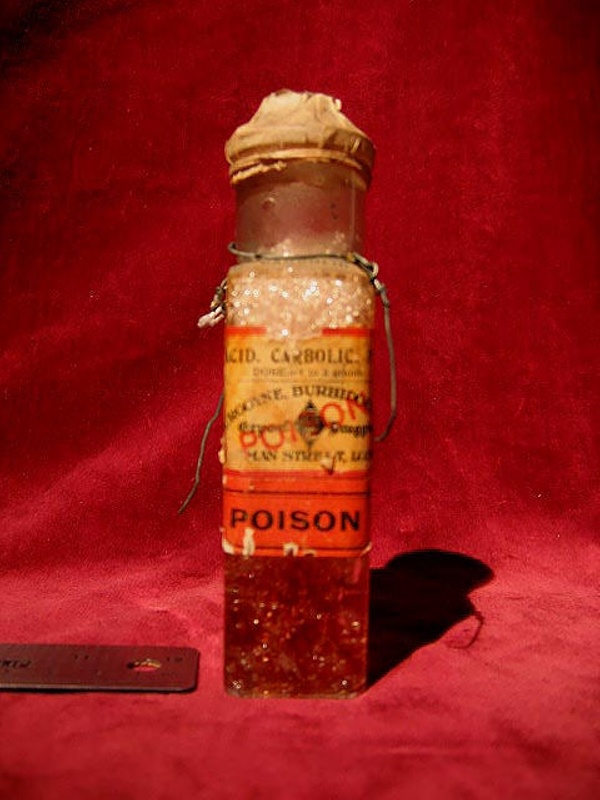 Sealed Clear Glass Bottle with Wrapped Closure and Paper Label ...