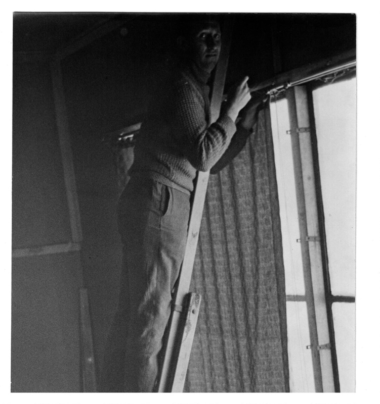 Black and White Photograph -Man up ladder; McColl; AP 003408 | eHive