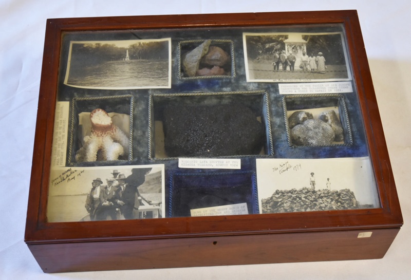 Presentation box with photographs (5), stones, coral (2), volcanic lava ...