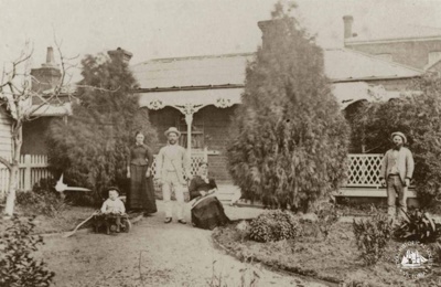 Three generations of David Aitken's family in yard of brick house at ...