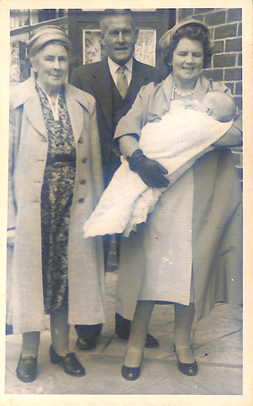 Black and white photograph of three people, one holding a baby ...