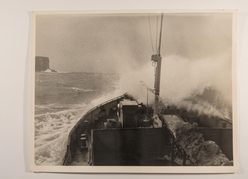 Black and white photo of waves crashing over bow of boat; 2019.82 | eHive