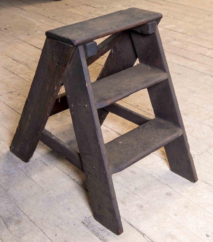 Wooden step ladder. Heavily oil soaked. Originally light coloured ...
